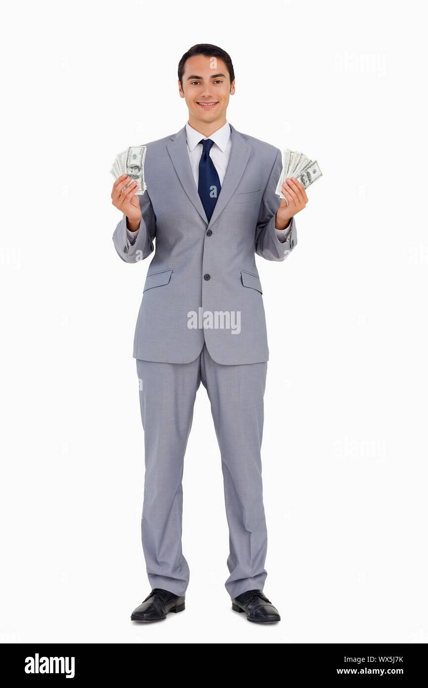 Portrait of a good-looking man with a lot of dollars against white ...