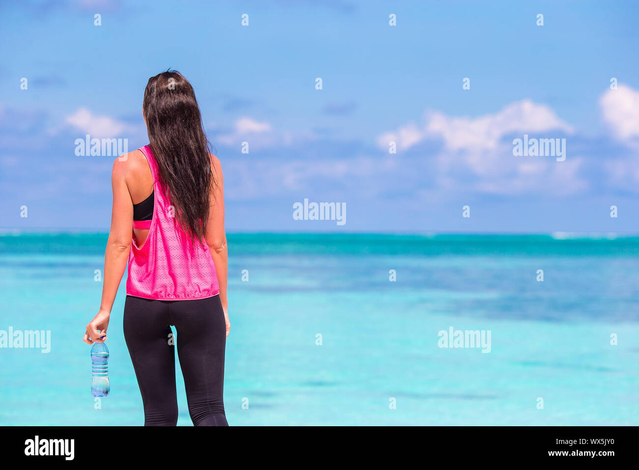 Fit young woman on the tropical beach in sportswear Stock Photo - Alamy