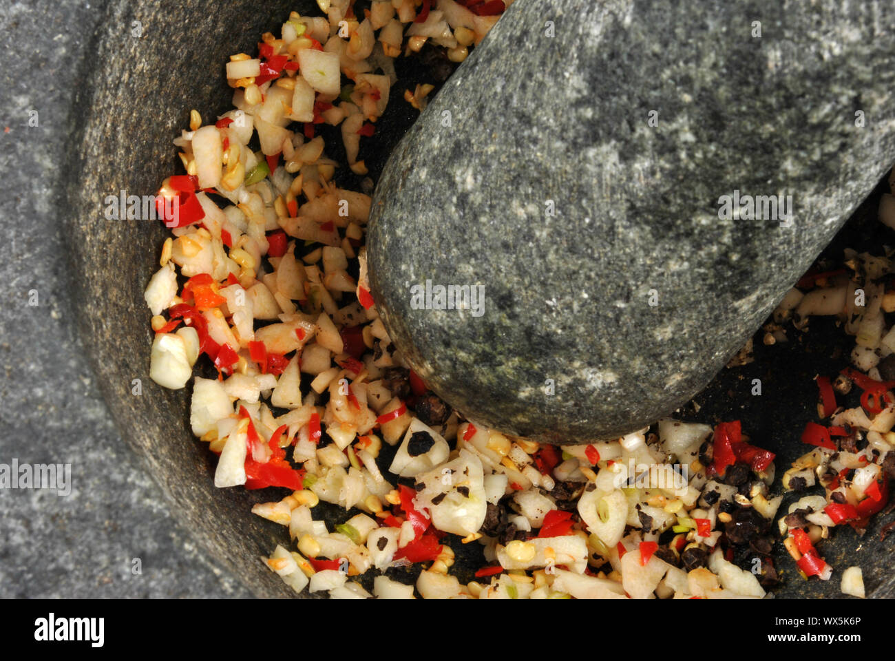some fresh crushed organic spices and pestle Stock Photo - Alamy