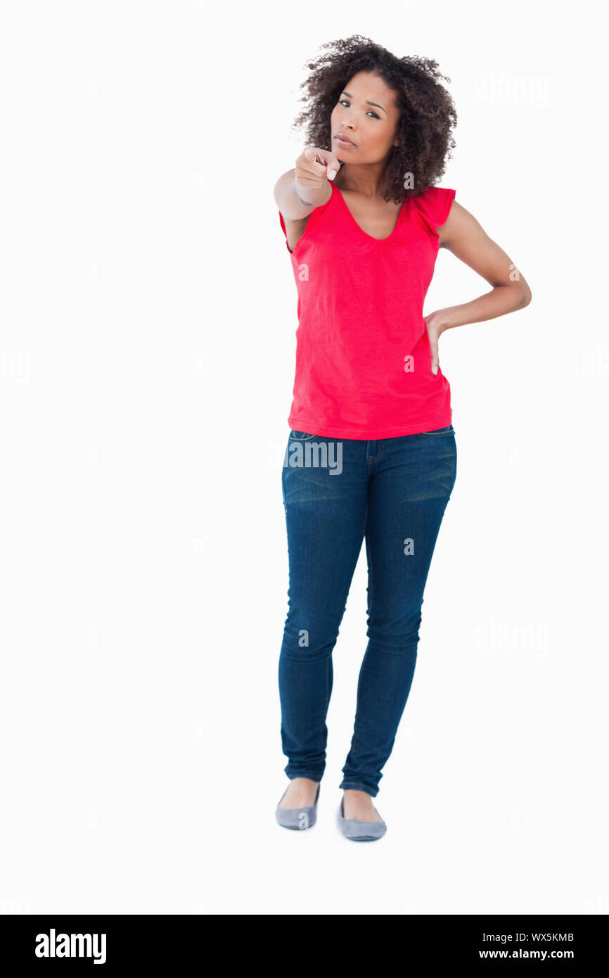 Serious woman accusing someone against a white background Stock Photo ...