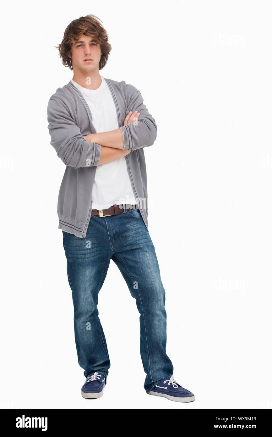 Male student posing with crossed arms against white background Stock ...