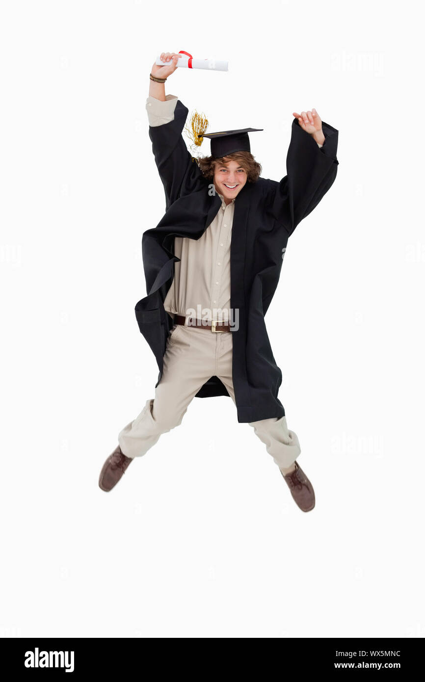 Male student in graduate robe jumping against white background Stock ...