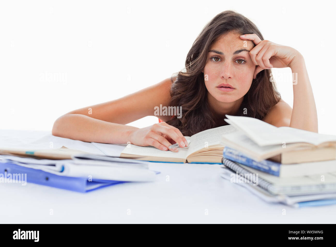 Bored student doing her homework against white background Stock Photo ...