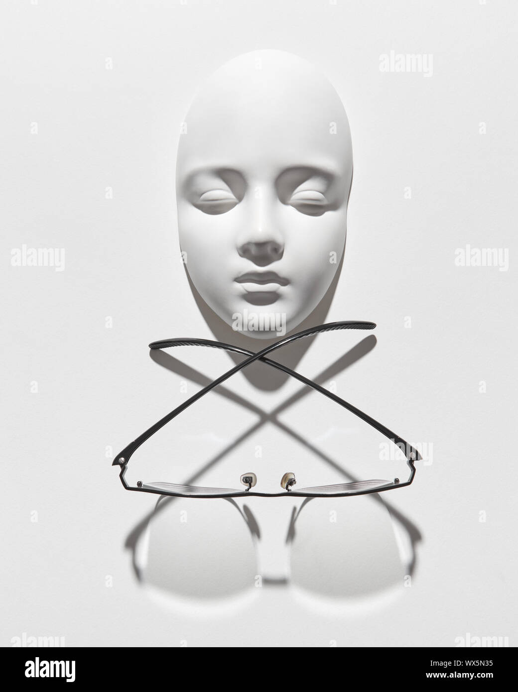 Gypsum face sculpture mask with stylish glasses, long crossing shadows ...