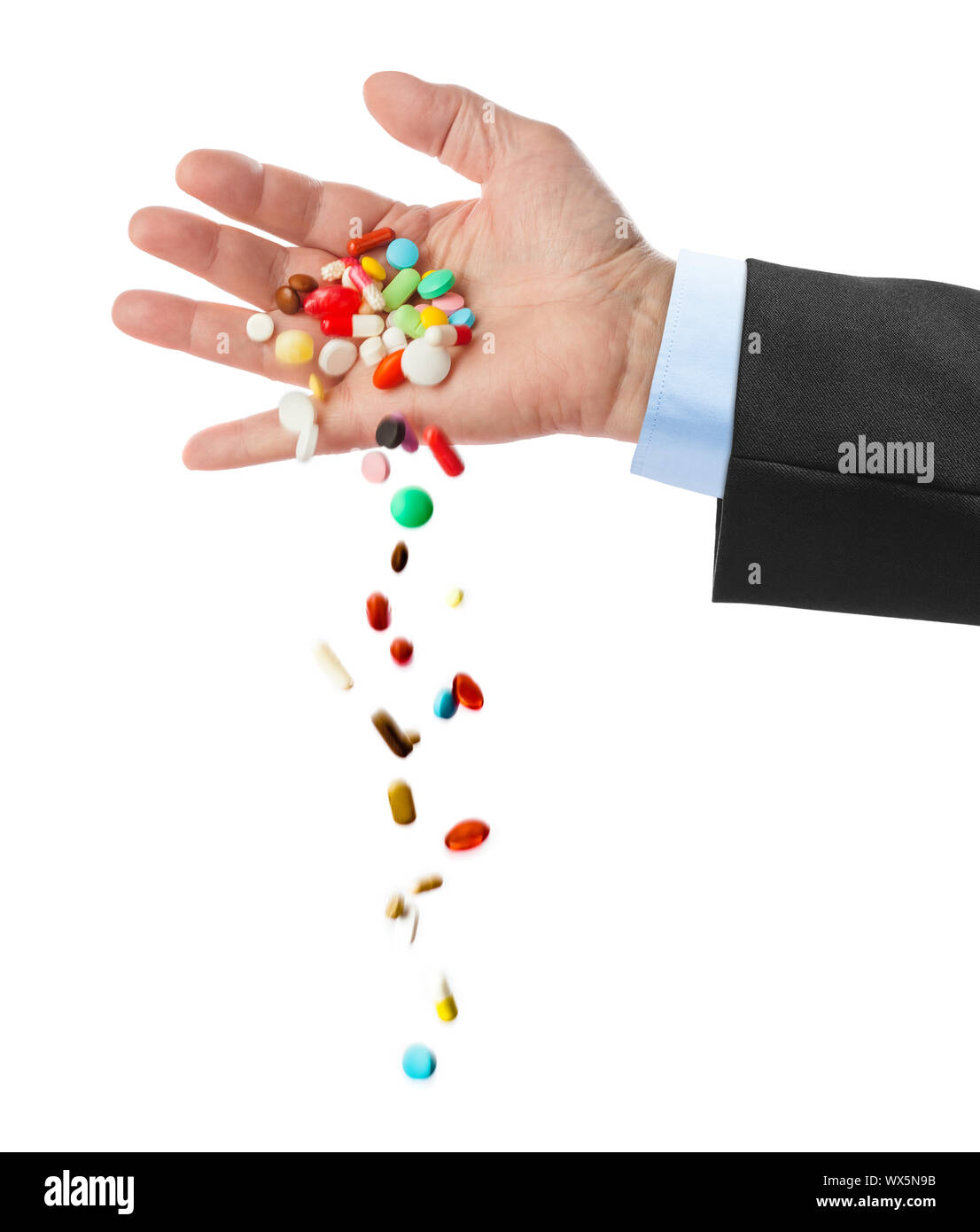 Hand and falling pills Stock Photo - Alamy