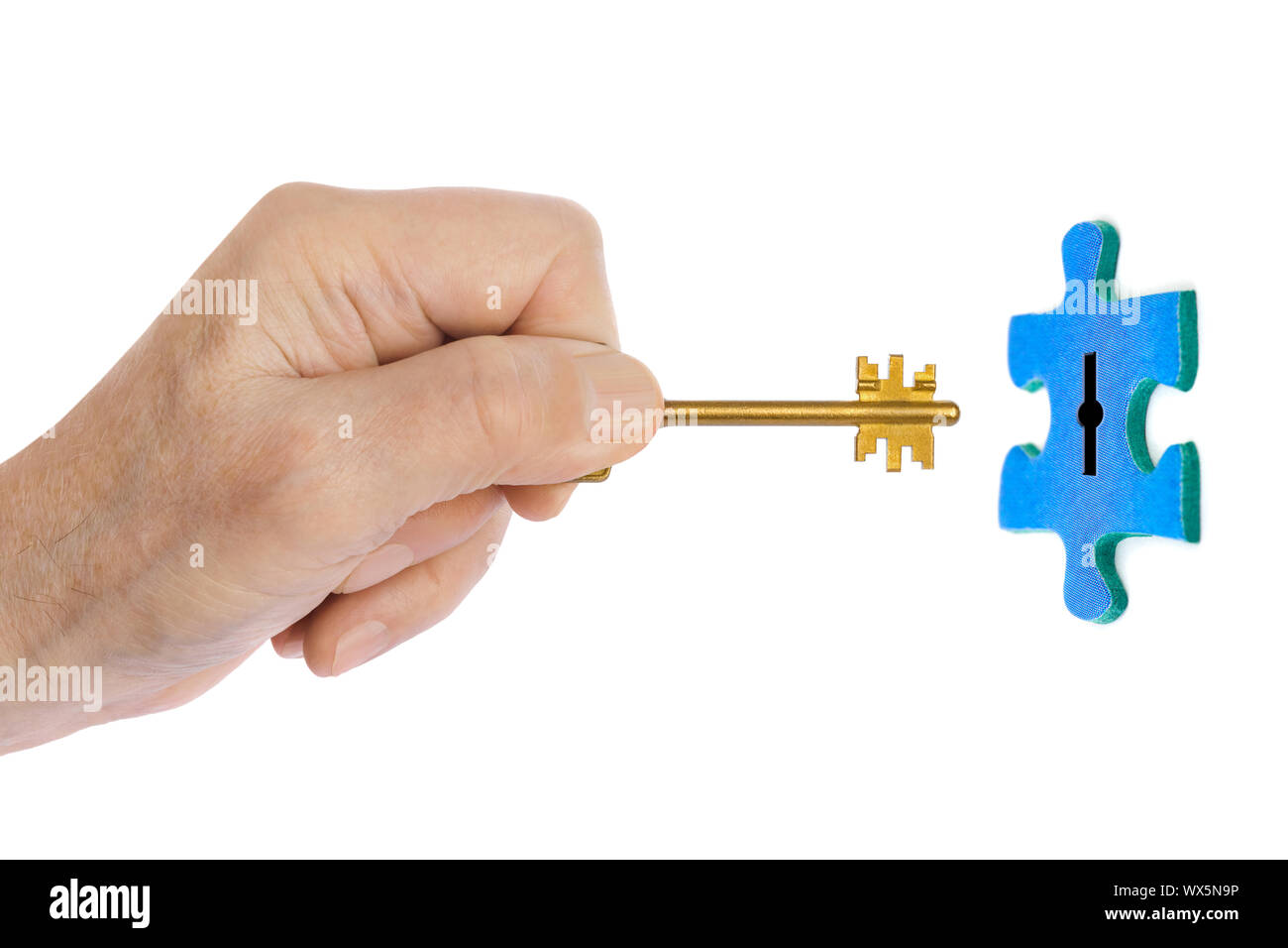 Hand with key and puzzle Stock Photo - Alamy