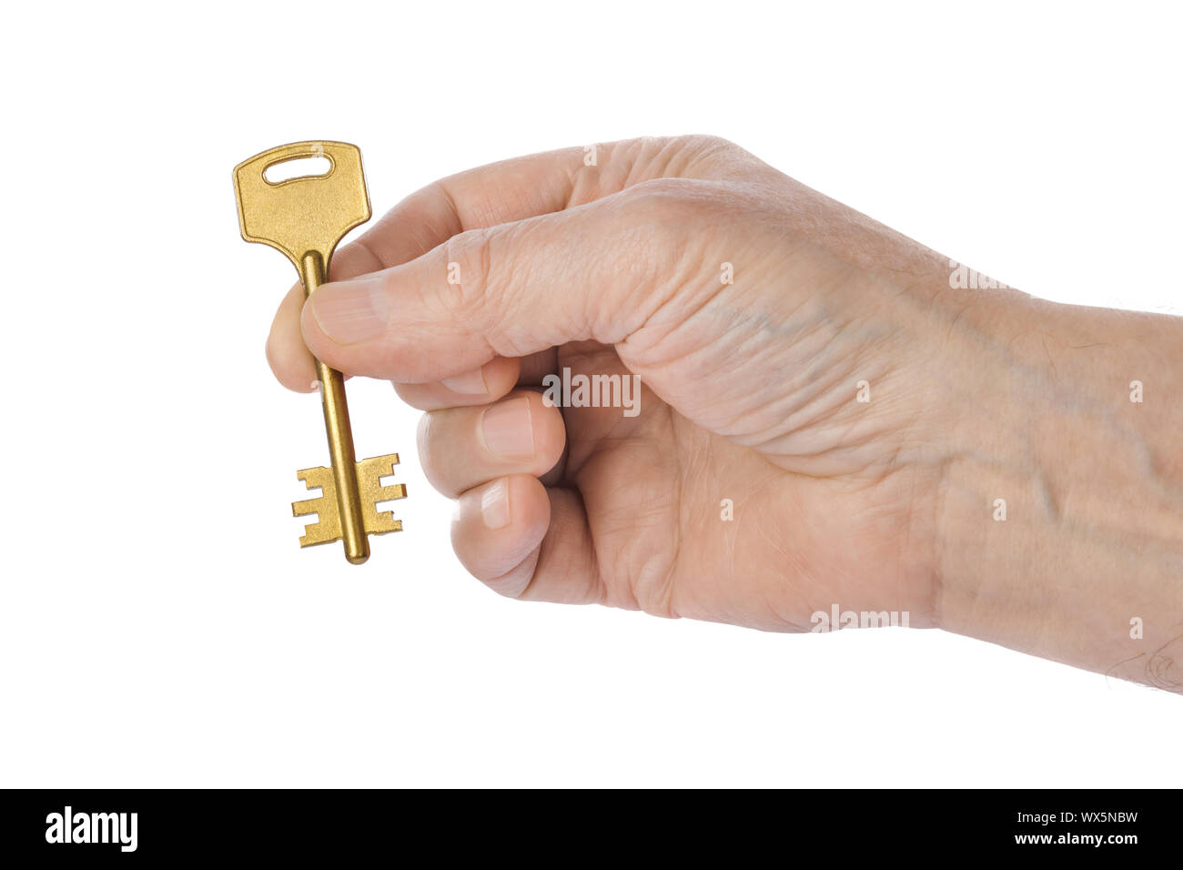 Hand with gold key Stock Photo - Alamy