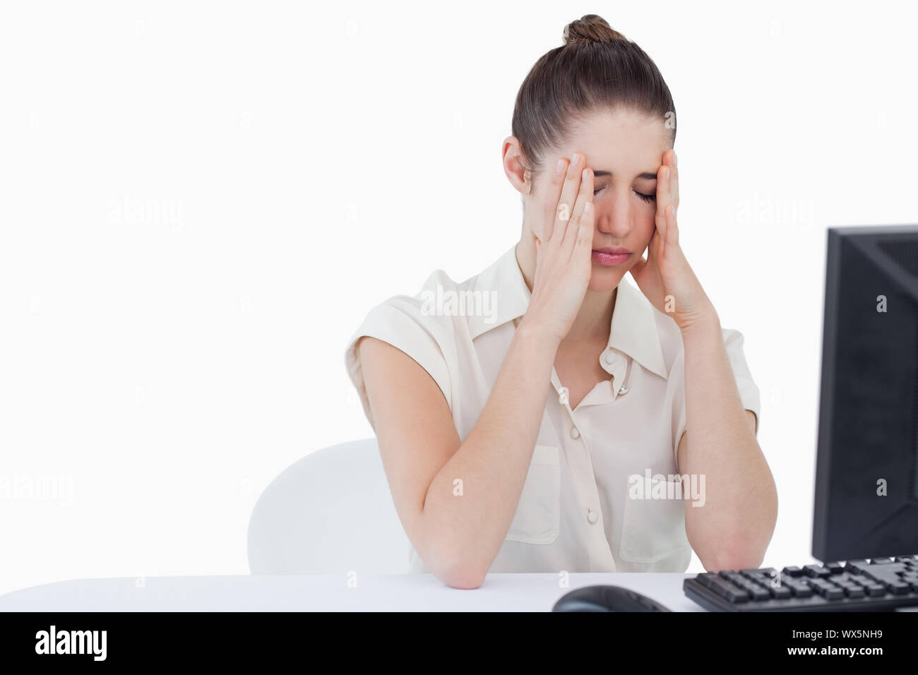Worried secretary using a computer against a white background Stock ...