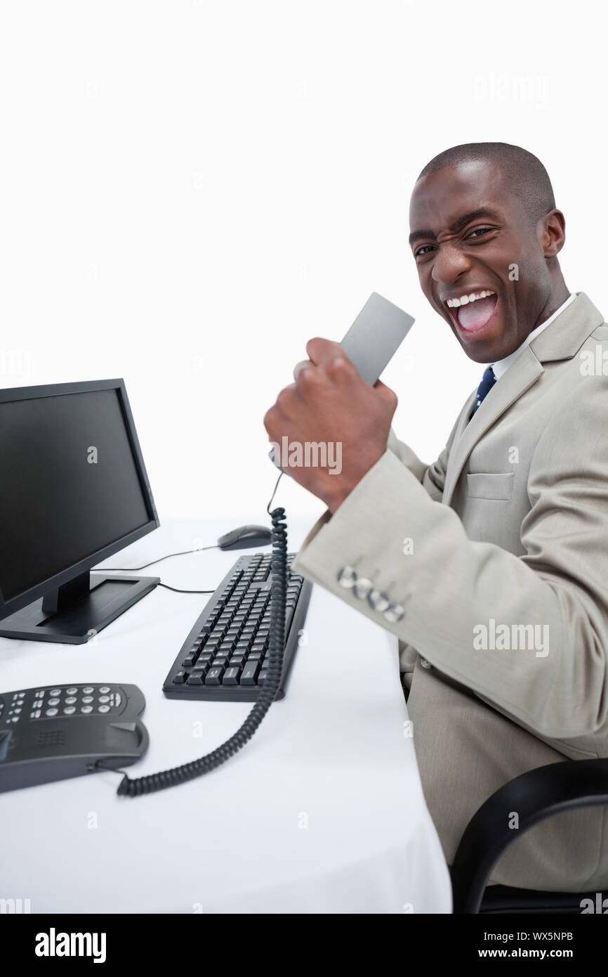 Portrait of a successful businessman using a computer against a white ...