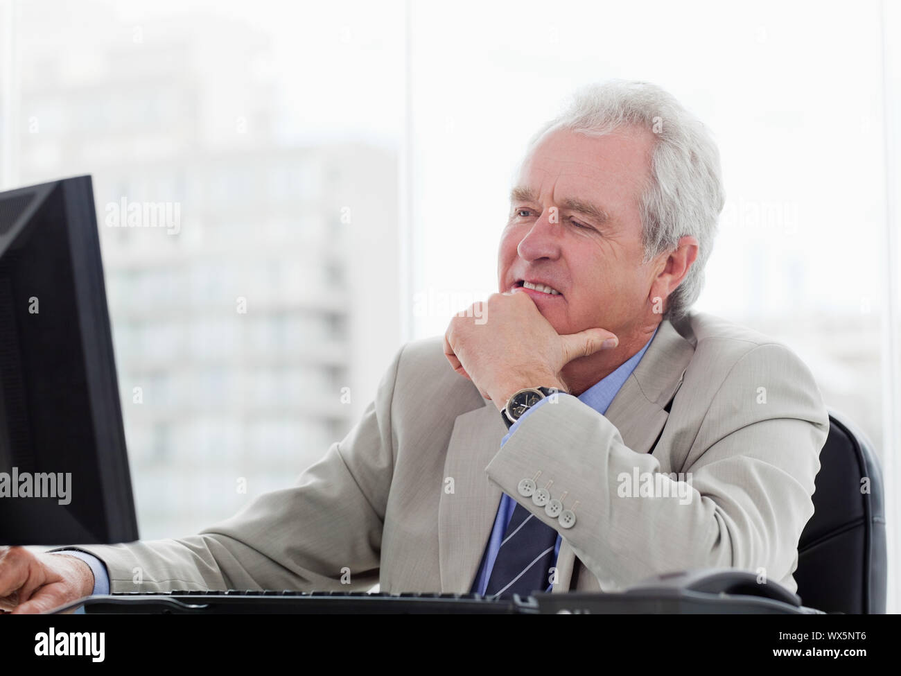 Happy senior manager working with a monitor in his office Stock Photo ...