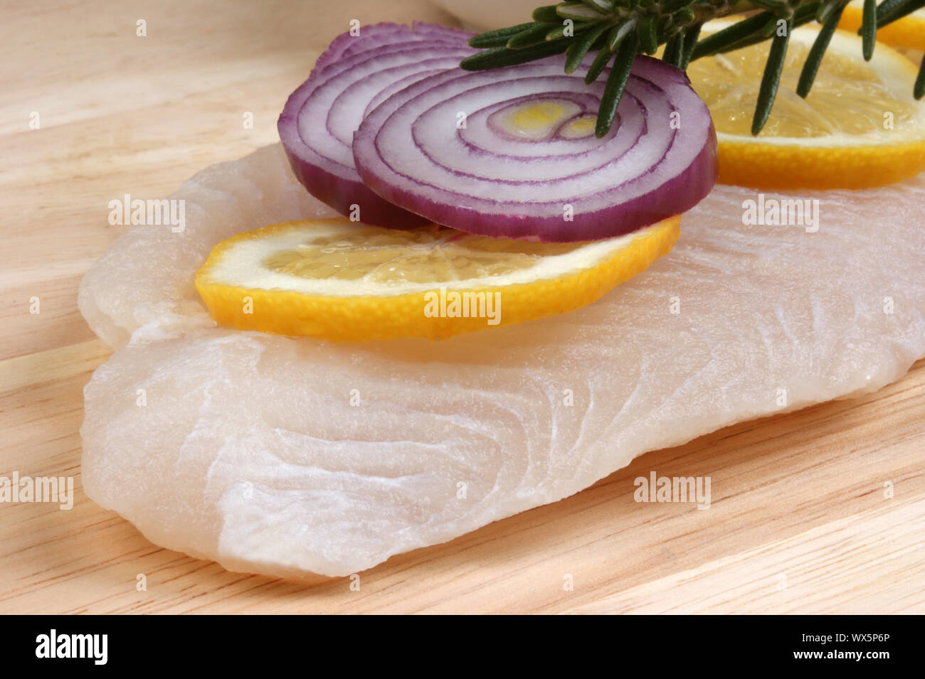 raw vietnamese river cobbler fillet on a timber board Stock Photo - Alamy