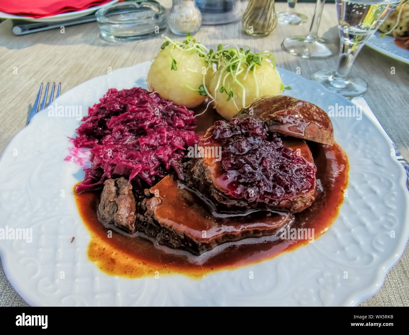 Roast venison with red cabbage Stock Photo - Alamy