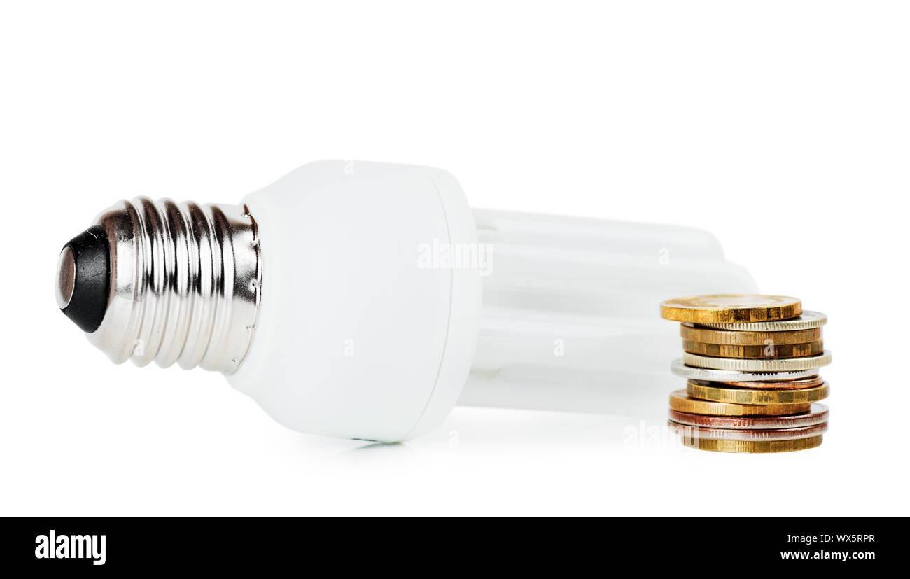 Light bulb and stack of coins over white background Stock Photo - Alamy