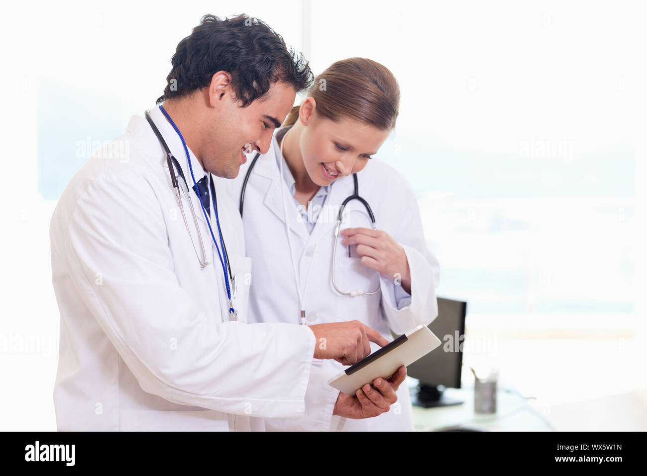 Young medical assistants looking at clip board Stock Photo - Alamy