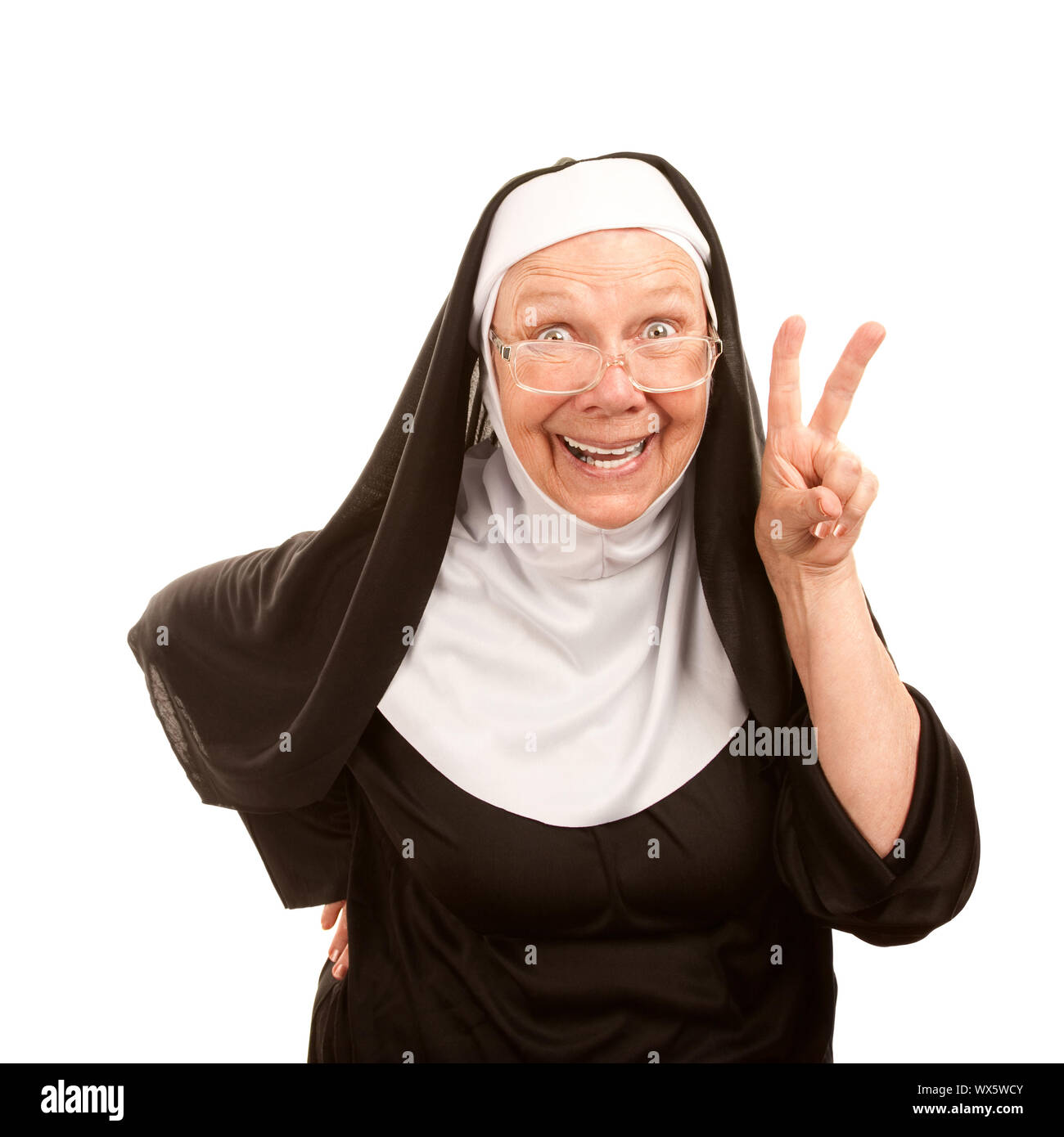 Funny nun on white background making peace sign Stock Photo - Alamy