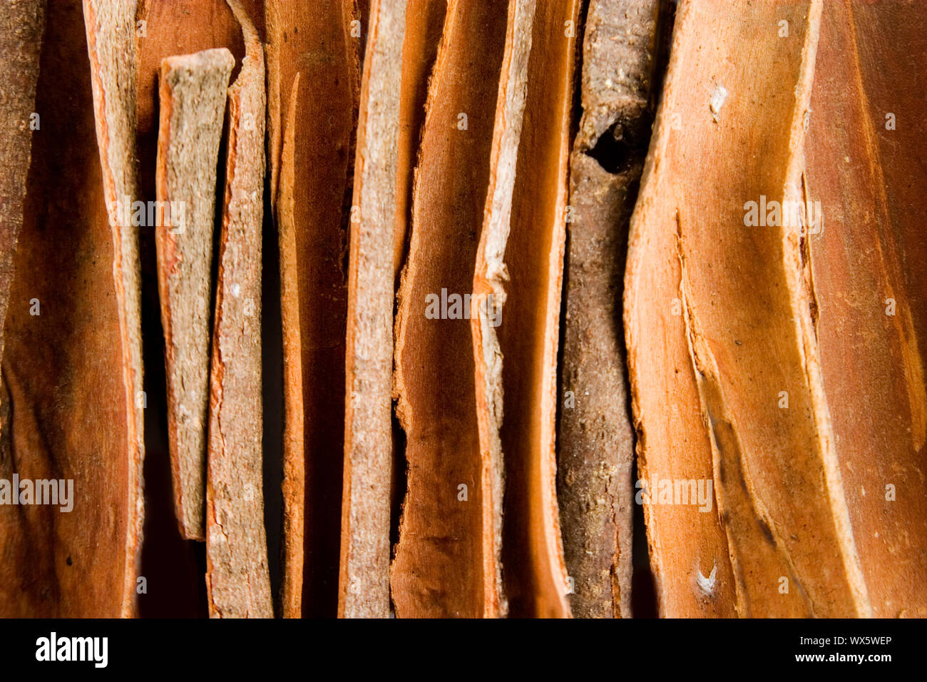 Bulk cinnamon sticks background texture Stock Photo - Alamy