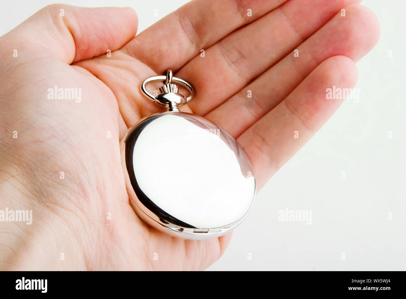 A male hand holding a fancy pocket watch Stock Photo - Alamy