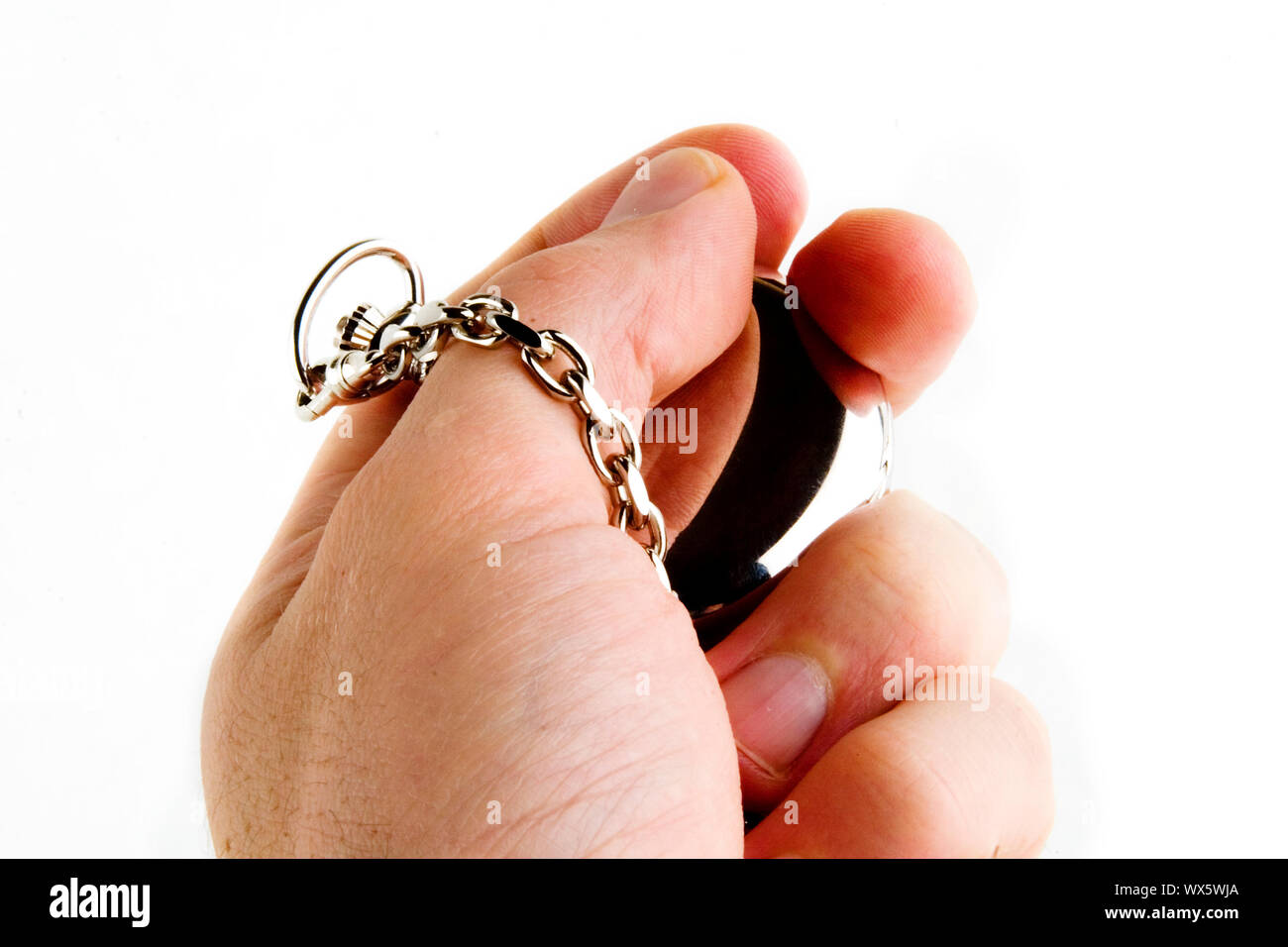 A male hand holding a fancy pocket watch Stock Photo - Alamy