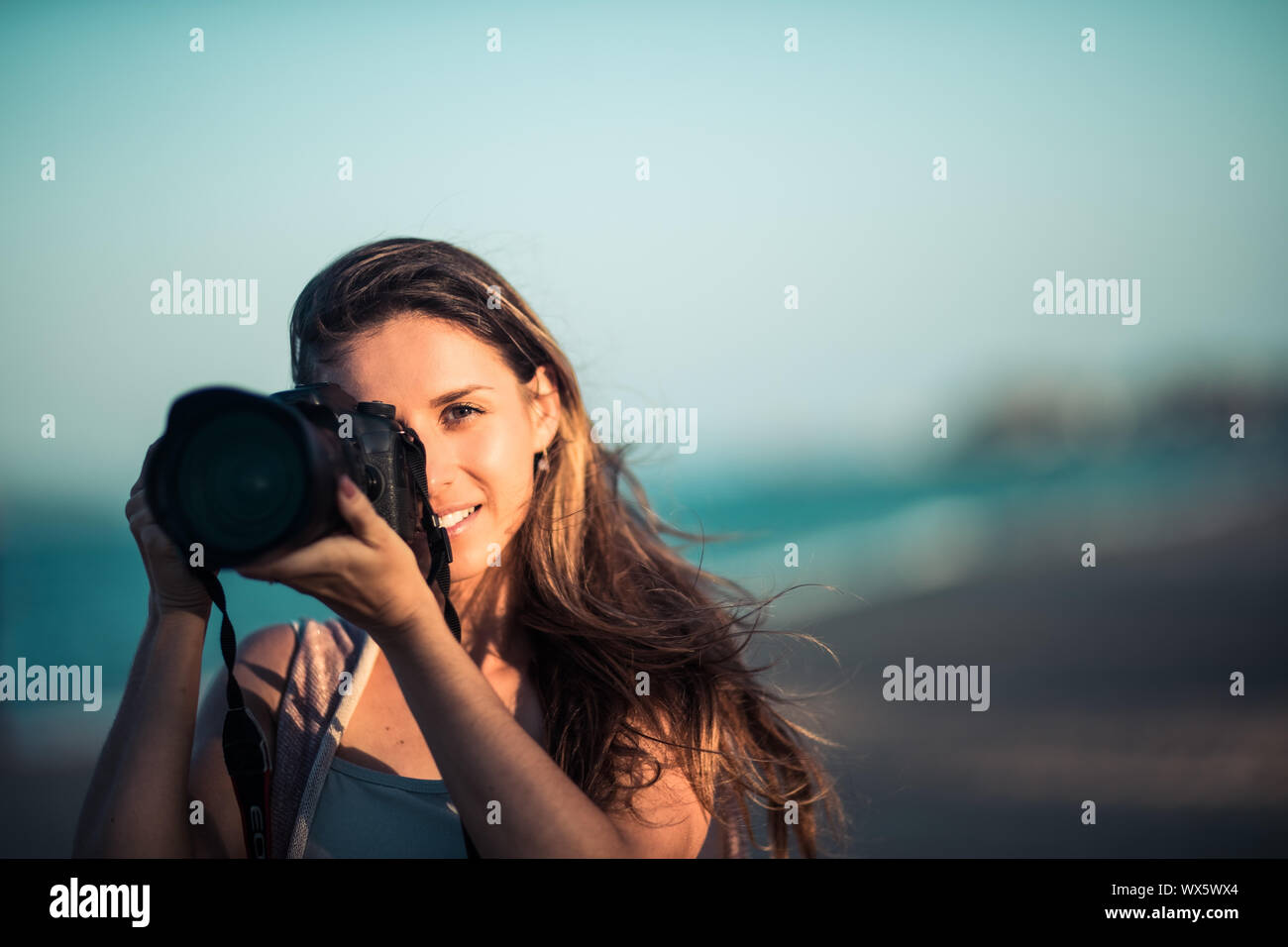 Portrait of a woman photographer with camera Stock Photo - Alamy