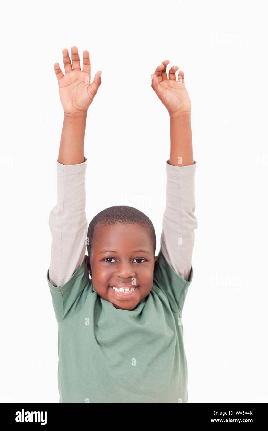 Portrait of a boy raising his arms against a white background Stock ...