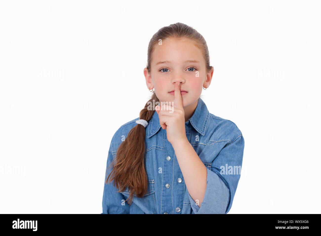 Girl asking for silence against a white background Stock Photo - Alamy