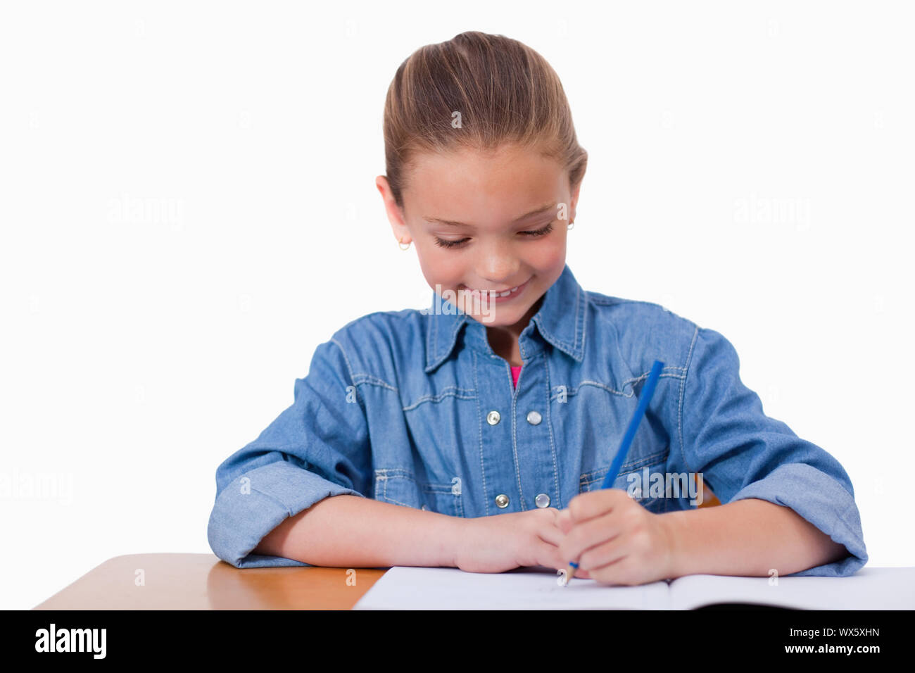 Little girl writing against a white background Stock Photo - Alamy