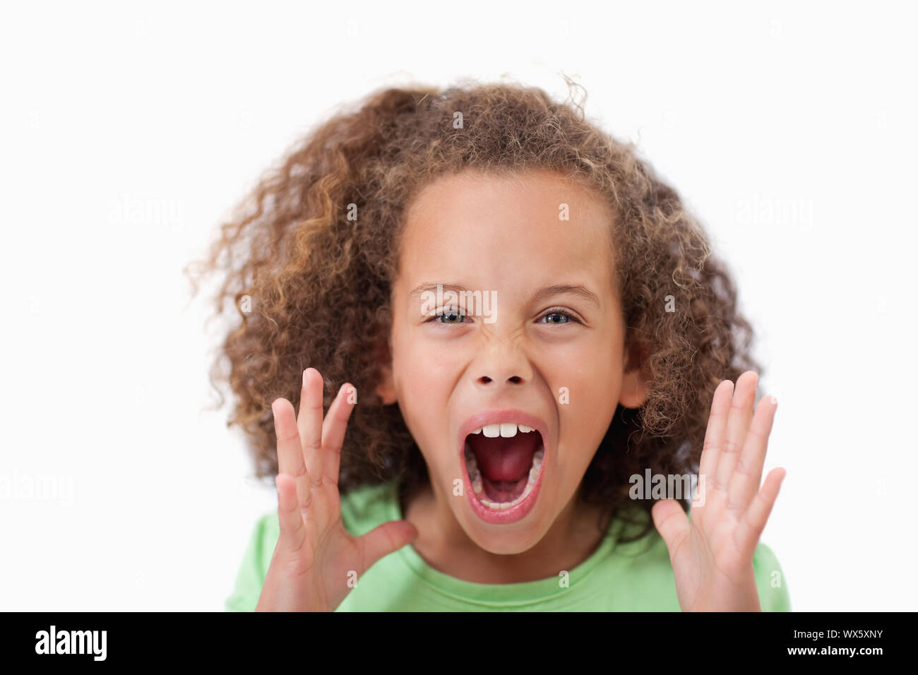 Angry girl screaming against a white background Stock Photo - Alamy