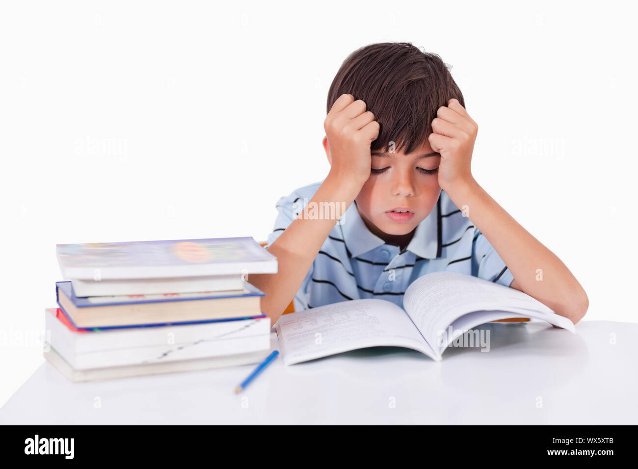 Focused boy learning his lessons against a white background Stock Photo ...