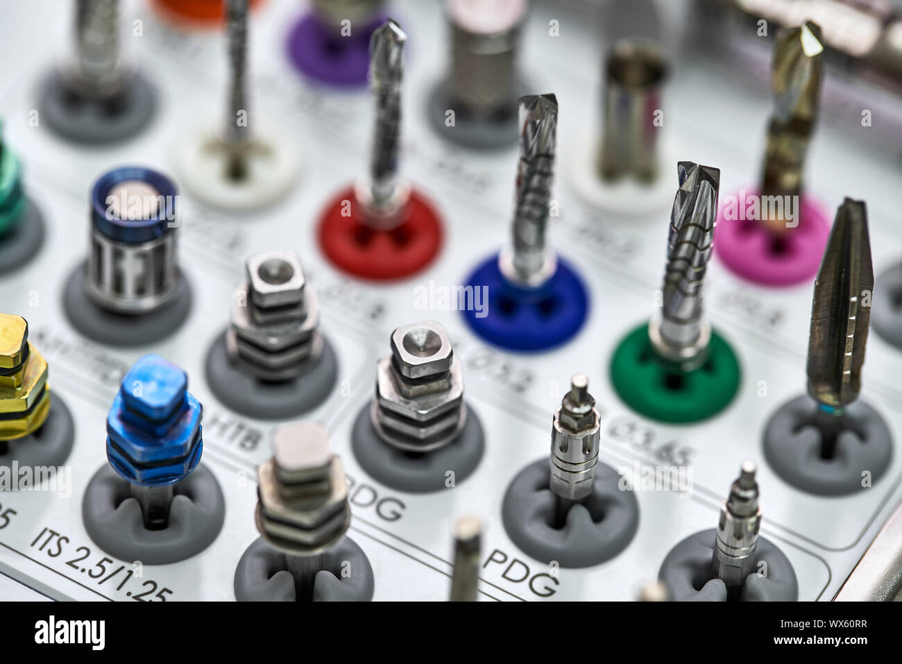 Rows of different sizes steel drills and tools for dental prosthetic ...