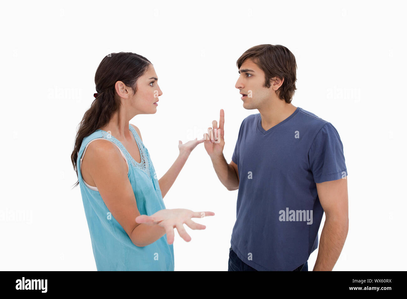 Angry couple arguing against a white background Stock Photo - Alamy