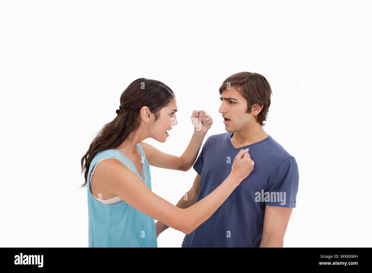 Couple having an argument against a white background Stock Photo - Alamy