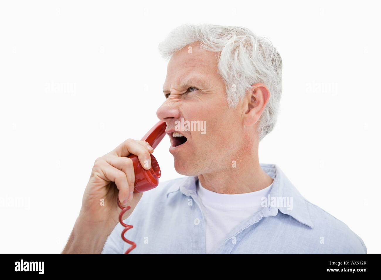 Angry man making a phone call against a white background Stock Photo ...