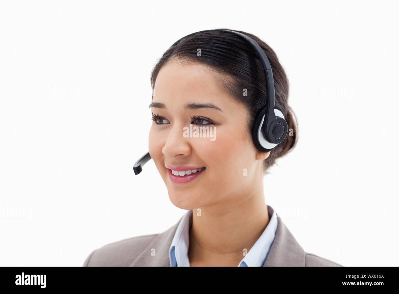 Happy operator posing with a headset against a white background Stock ...