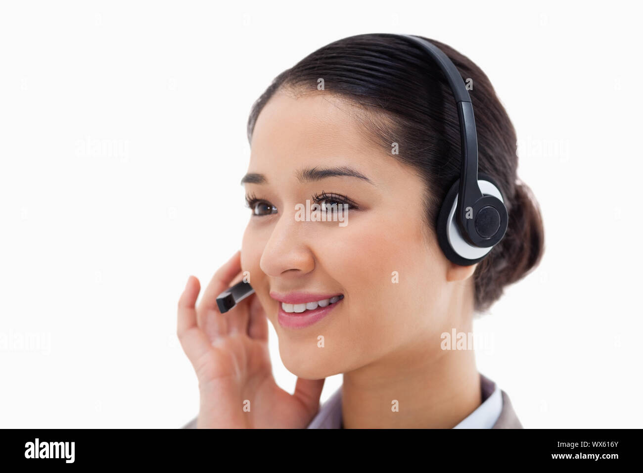 Close up of an operator posing with a headset against a white ...