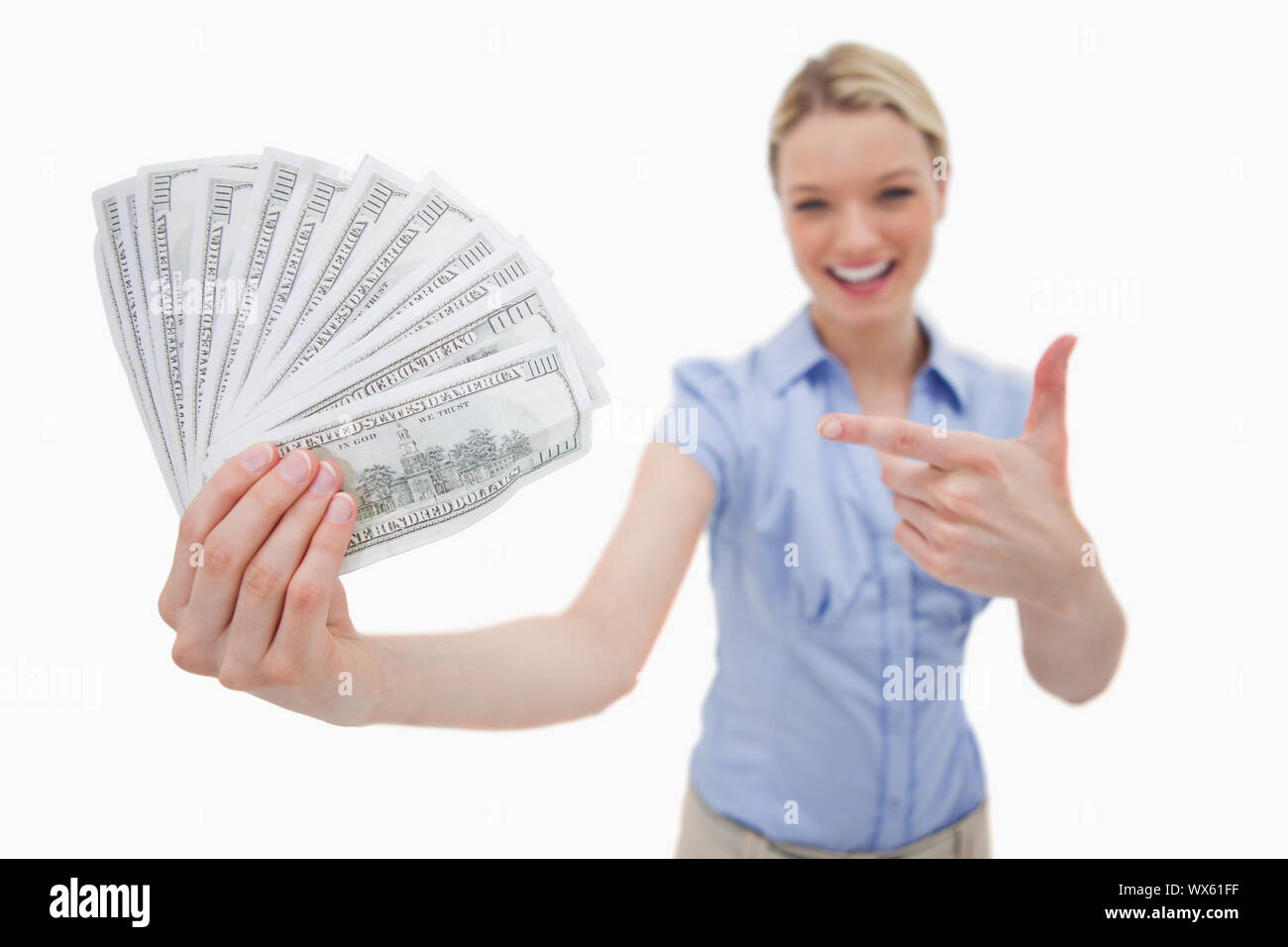 Money being held and pointed at by woman against a white background ...