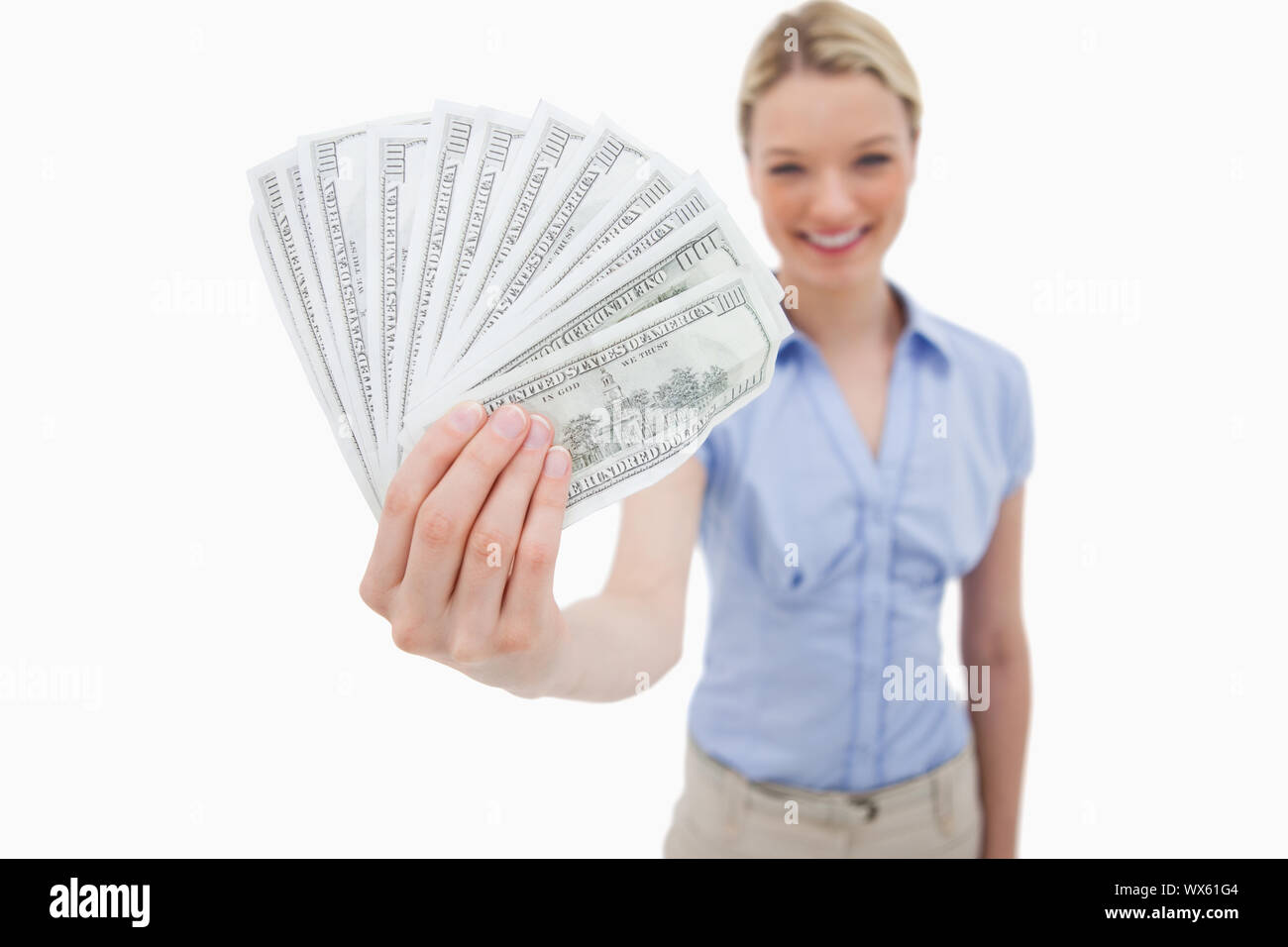 Money being held by smiling woman against a white background Stock ...