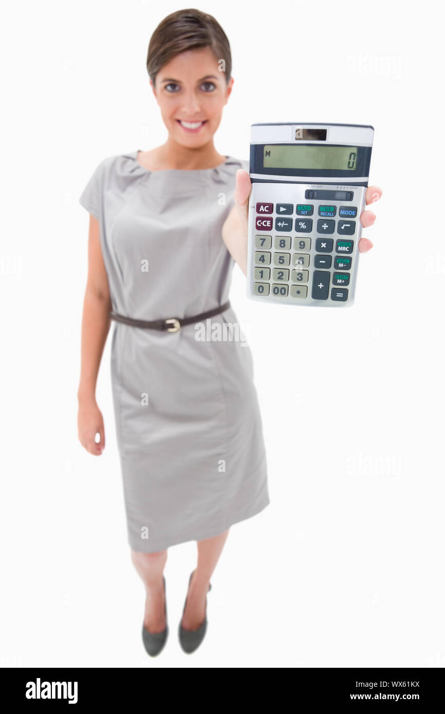 Woman showing hand calculator against a white background Stock Photo ...