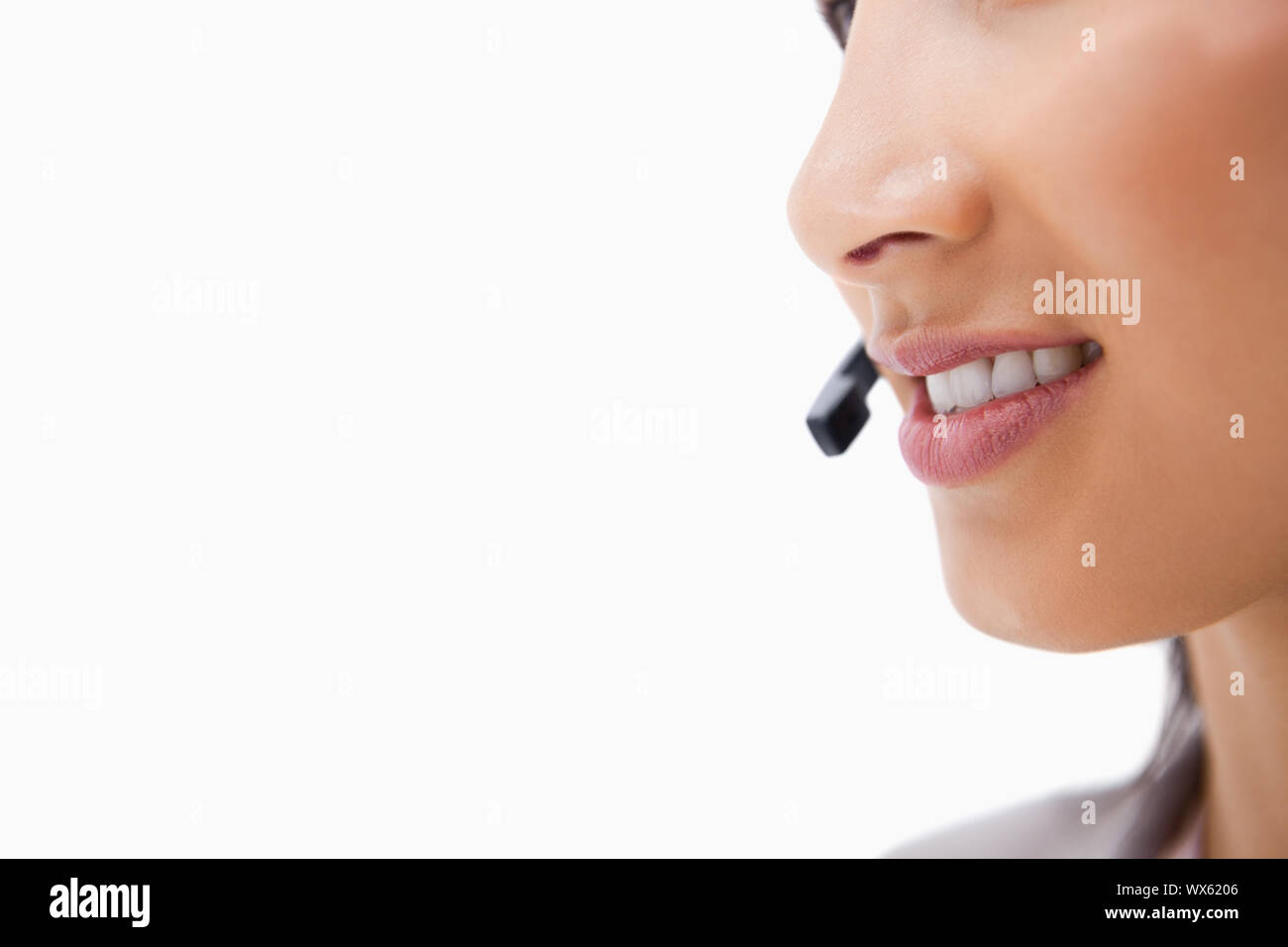 Side view of talking mouth of female call center agent against a white ...