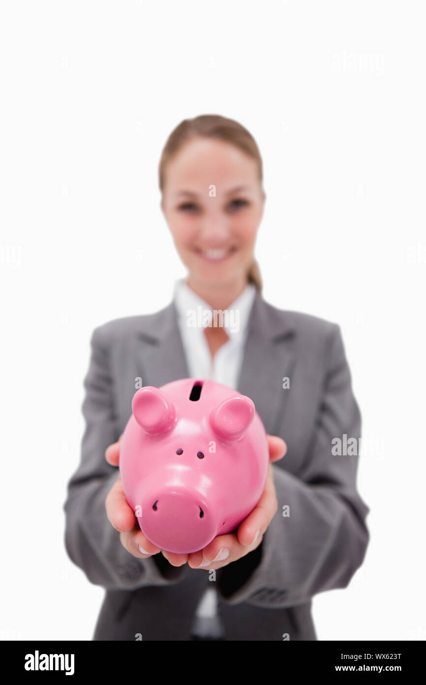 Piggy bank being held by smiling bank employee against a white ...