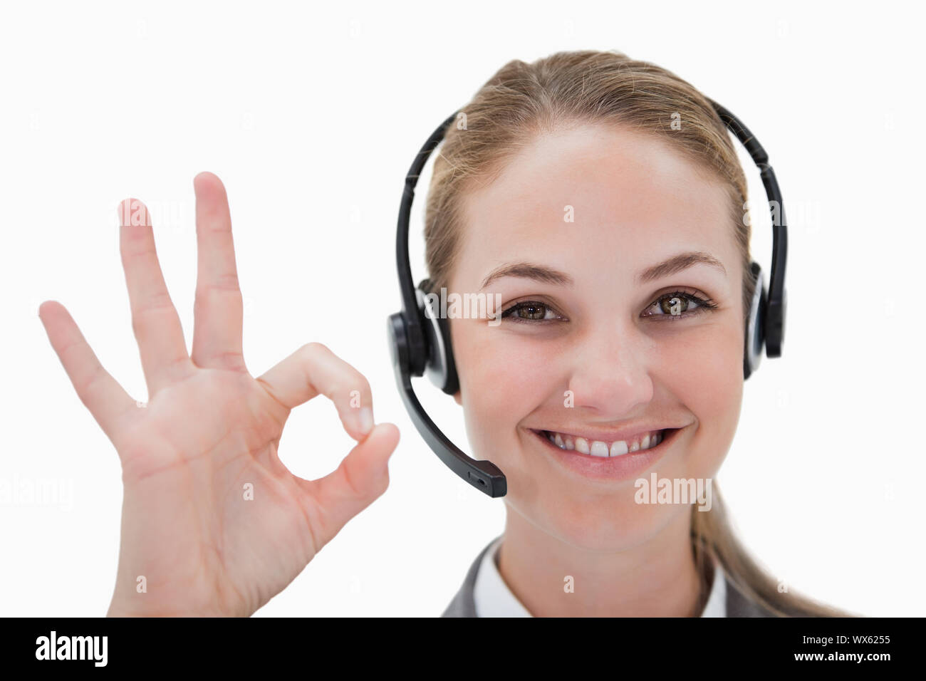 Smiling call center agent approving against a white background Stock ...