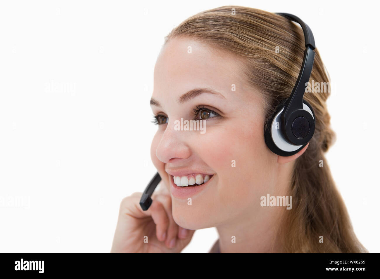 Side view of smiling call center agent against a white background Stock ...