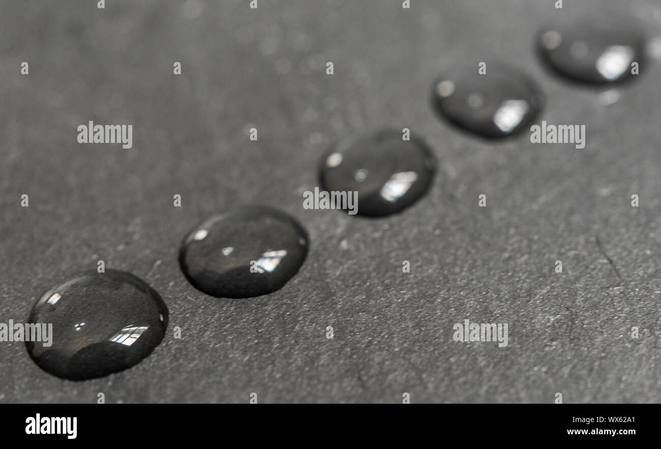 Water drops on a black slate background Stock Photo - Alamy