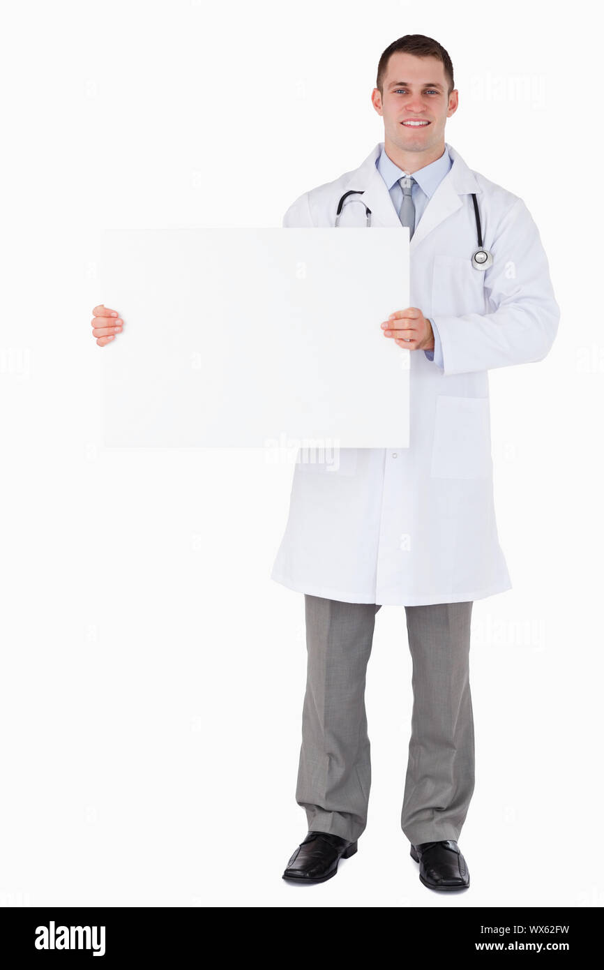 Standing doctor holding a sign to his right on white background Stock ...