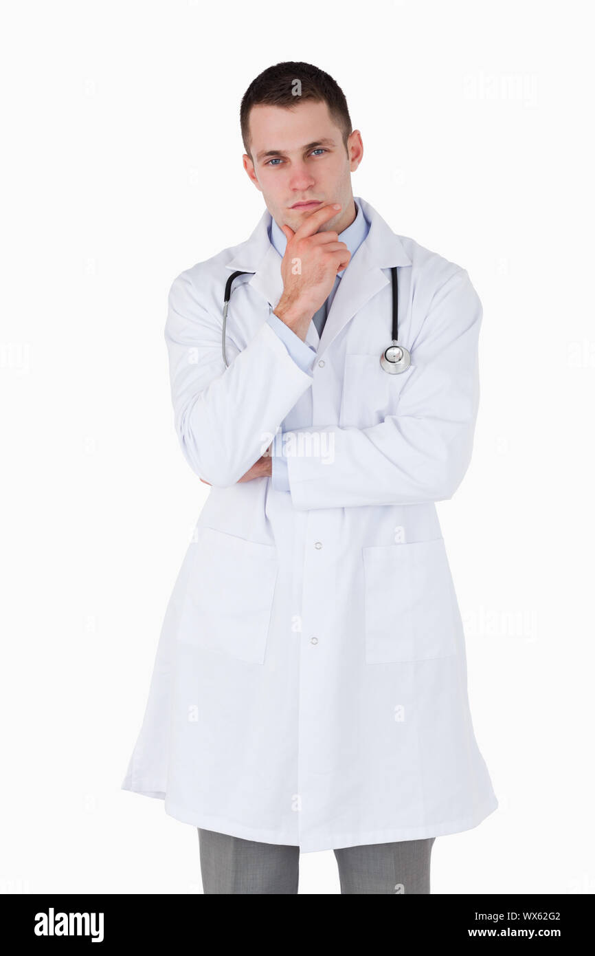 Thinking young doctor on white background Stock Photo - Alamy