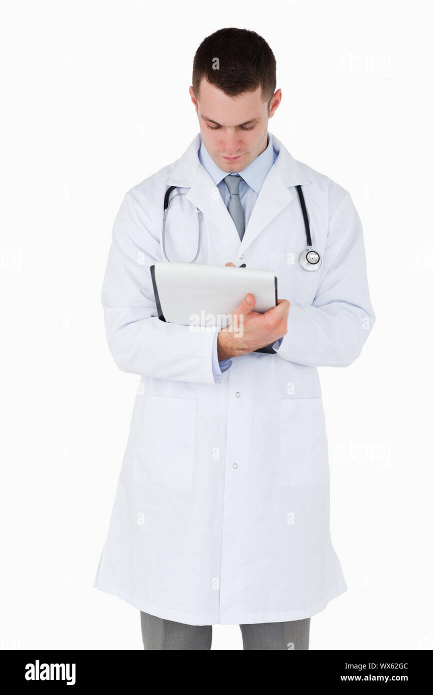 Doctor taking a careful look at his notes on white background Stock ...