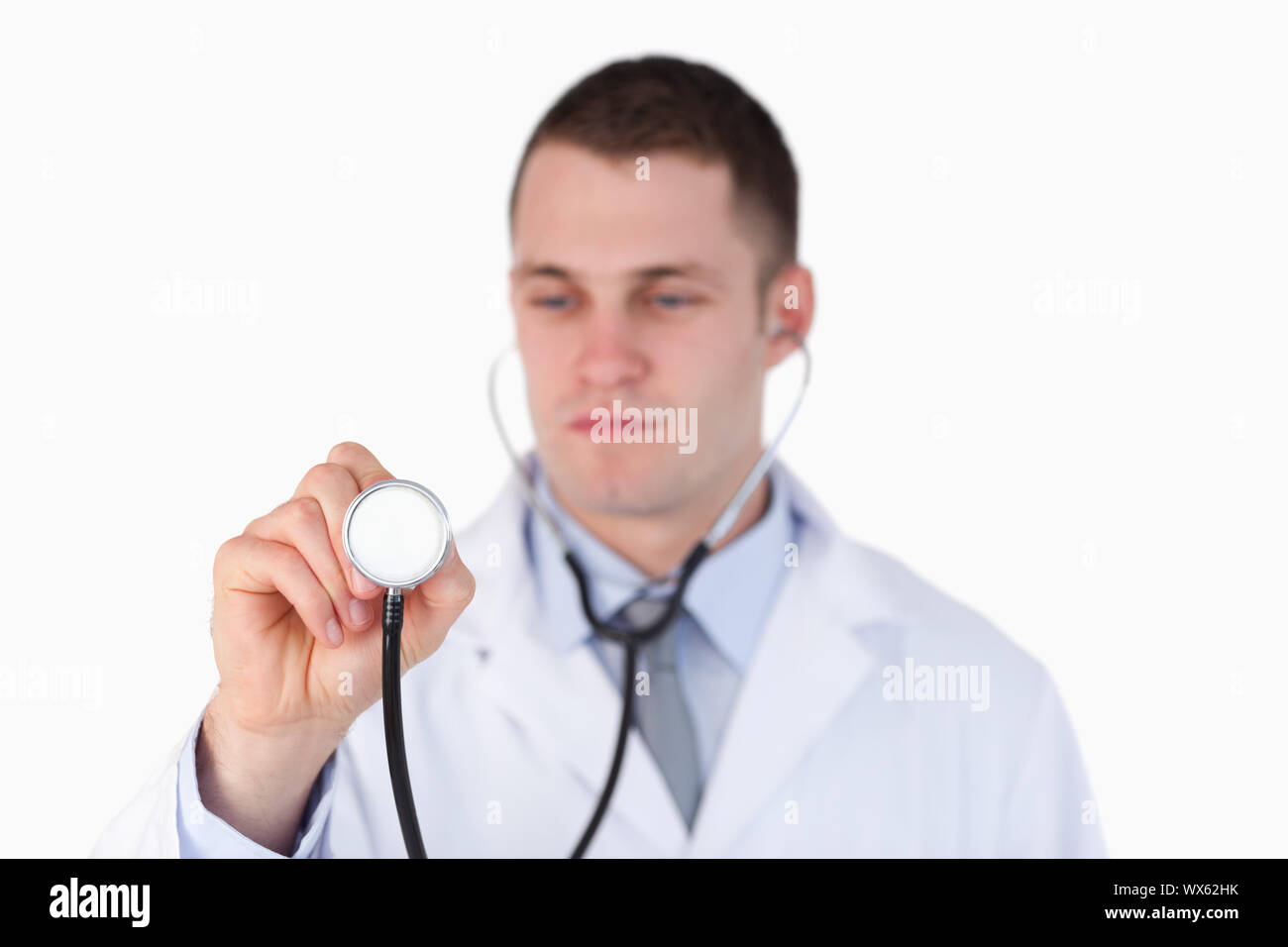 Close up of doctor looking at his stethoscope on white background Stock ...