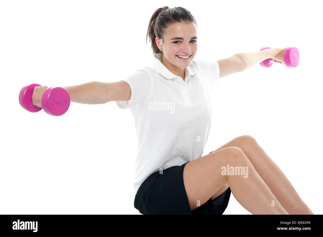 Healthy exercising fitness caucasian teenager holding dumbbells and ...