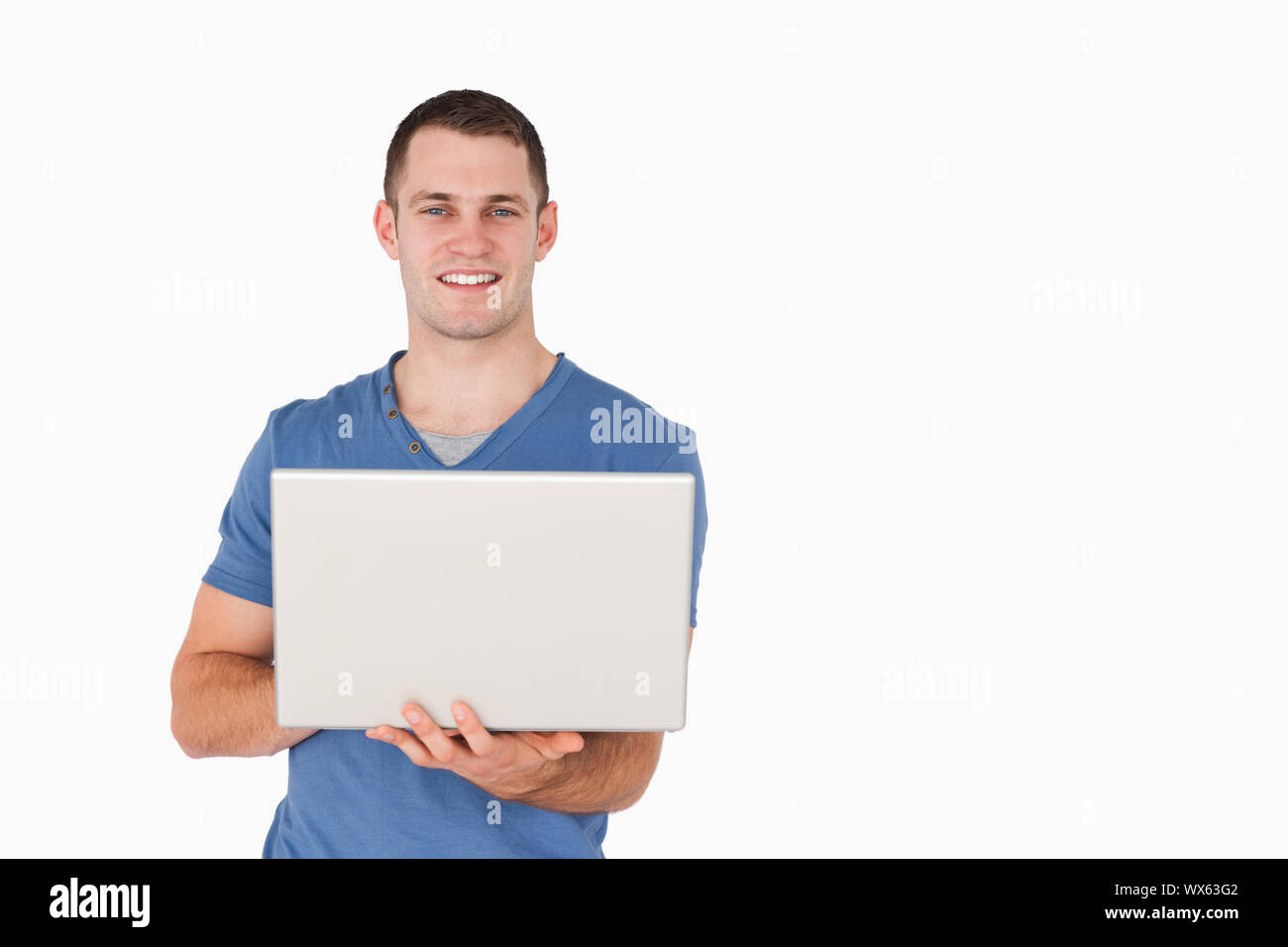 Man holding a laptop against a white background Stock Photo - Alamy