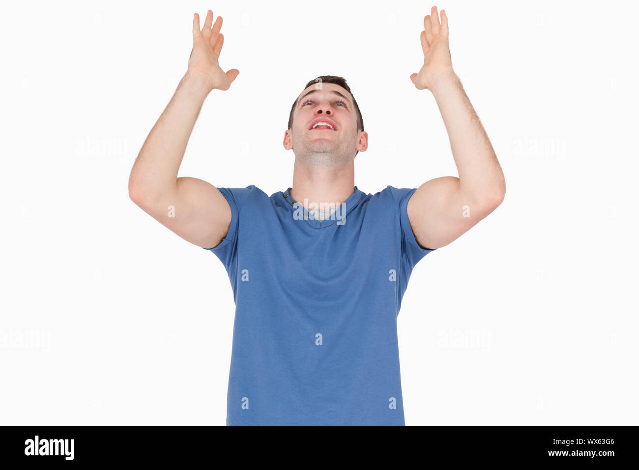 Relieved young man against a white background Stock Photo - Alamy