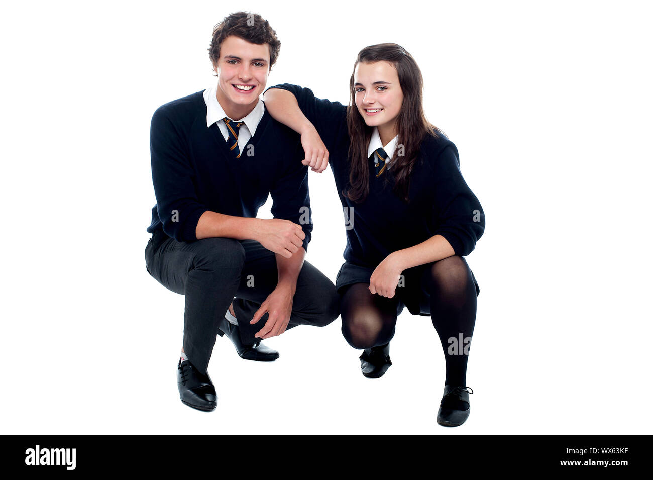 Girl resting hand on her friends shoulder, semi seated posture Stock ...